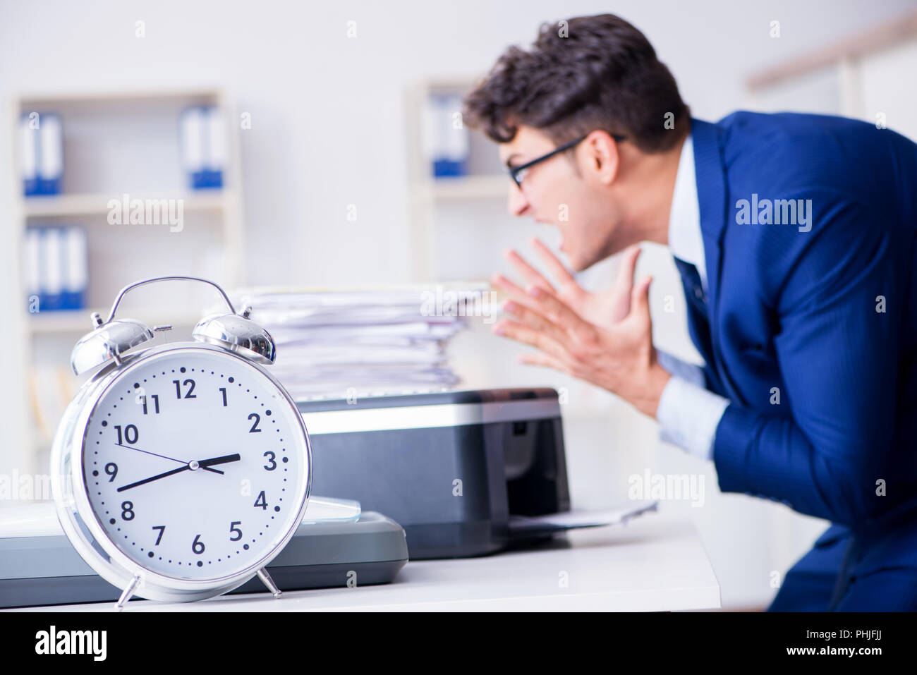 Businessman making copies in copying machine Stock Photo - Alamy