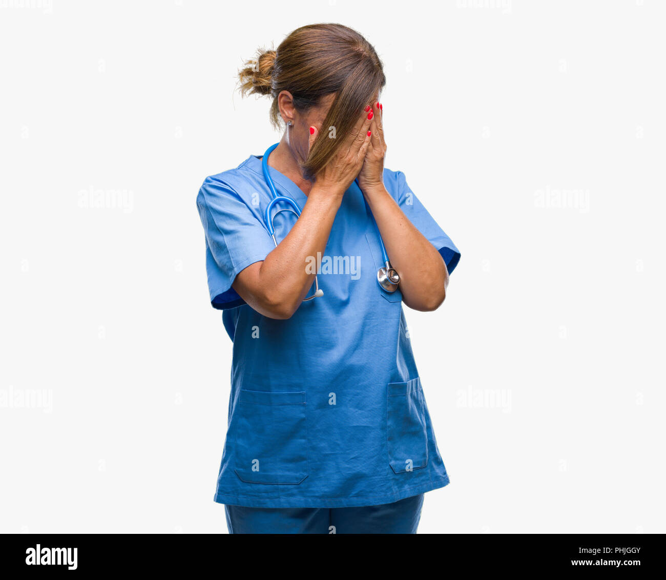Middle age senior nurse doctor woman over isolated background with sad ...