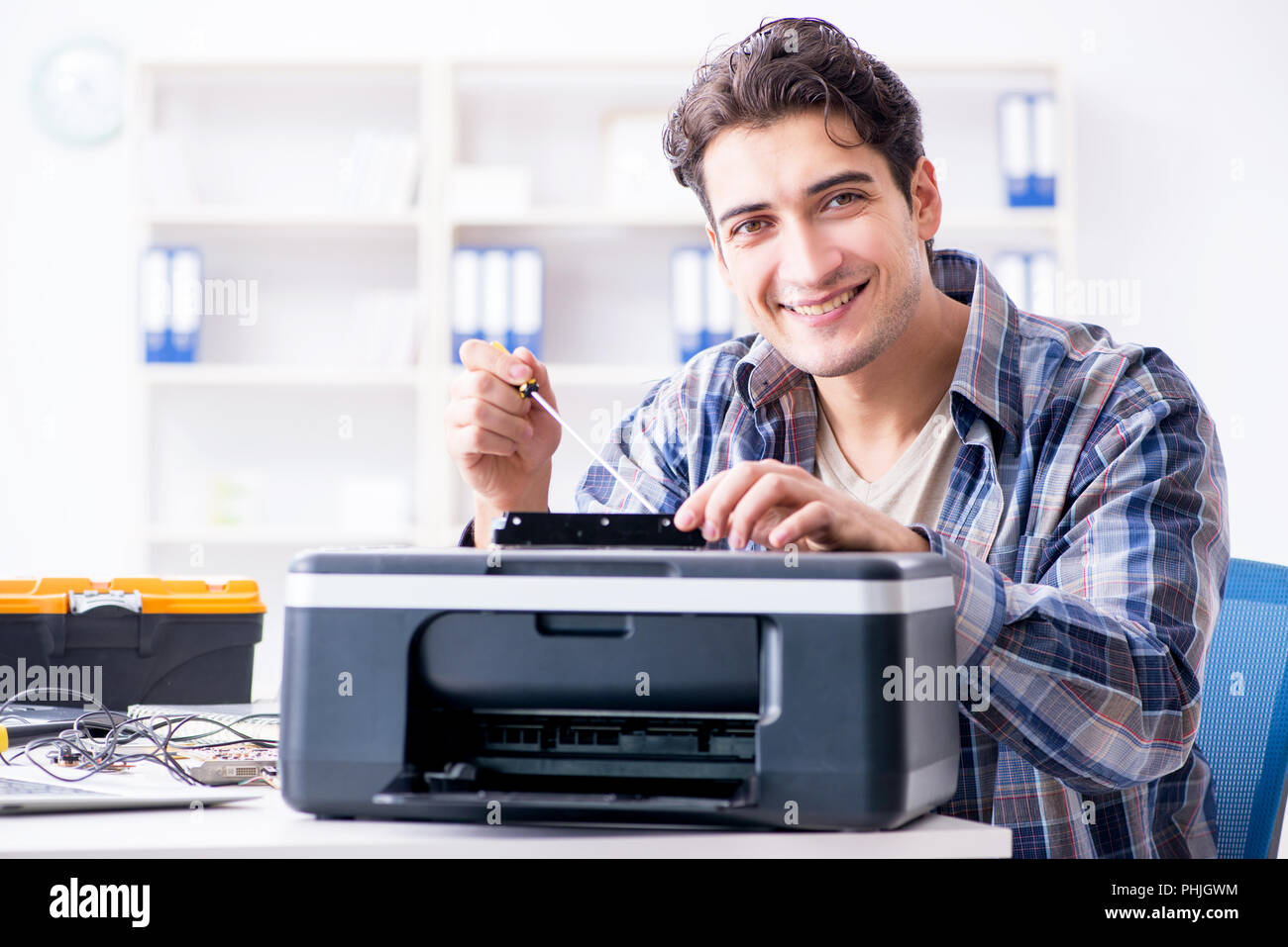 Hardware repairman repairing broken printer fax machine Stock Photo - Alamy