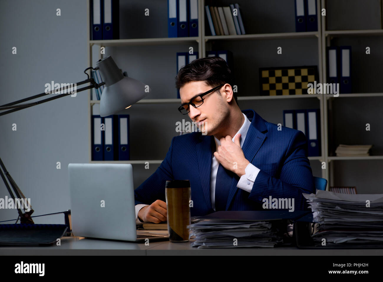 Employee working late to finish important deliverable task Stock Photo ...