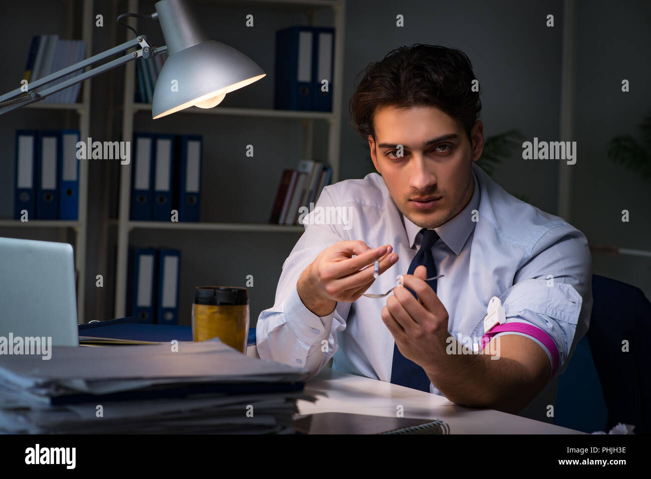 Employee relieving stress from overtime with drugs narcotics Stock ...