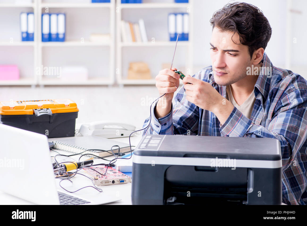 Hardware repairman repairing broken printer fax machine Stock Photo - Alamy