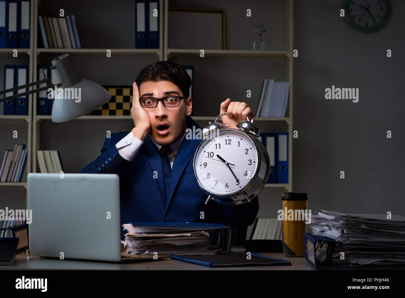 Employee staying late to finish work on auditing Stock Photo - Alamy