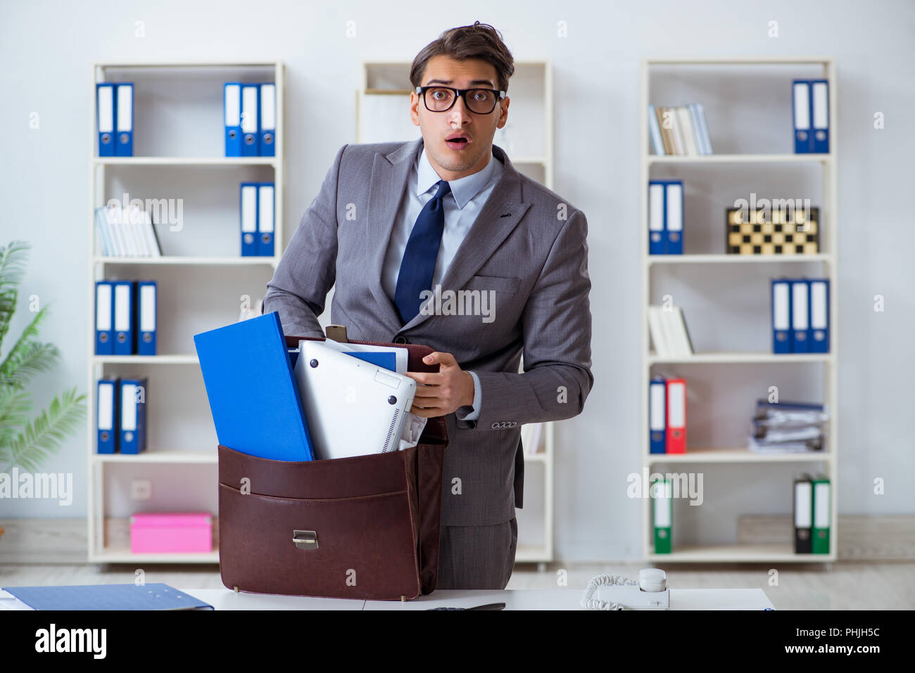 Employee with too much work taking it home Stock Photo - Alamy