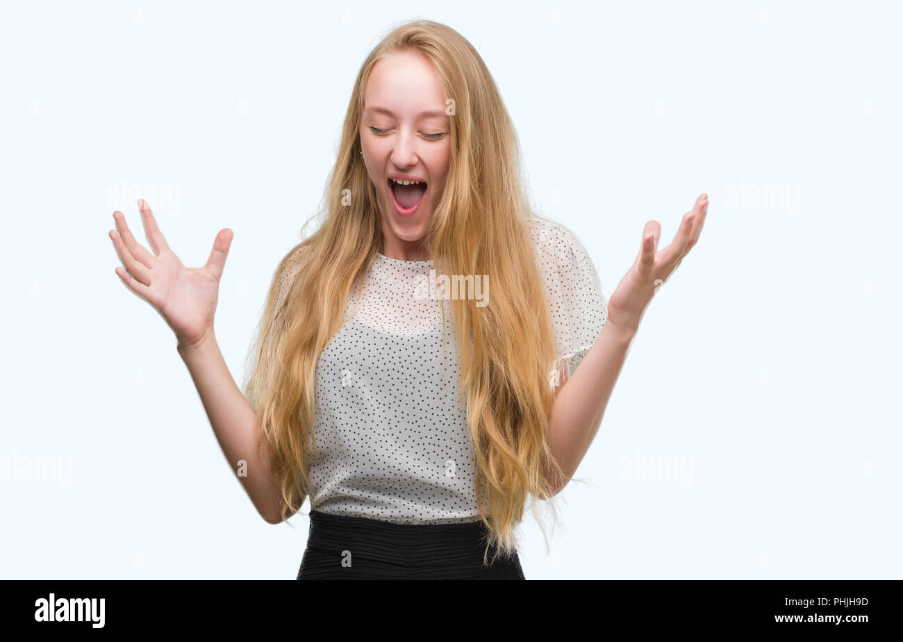 Blonde teenager woman wearing moles shirt celebrating mad and crazy for ...