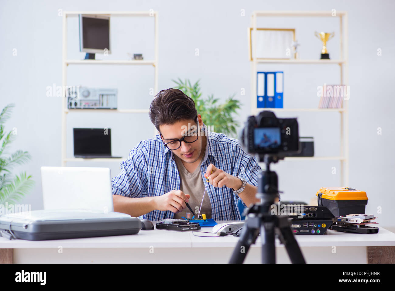 Vlogger recording computer repair on camera for vlog blog Stock Photo - Alamy