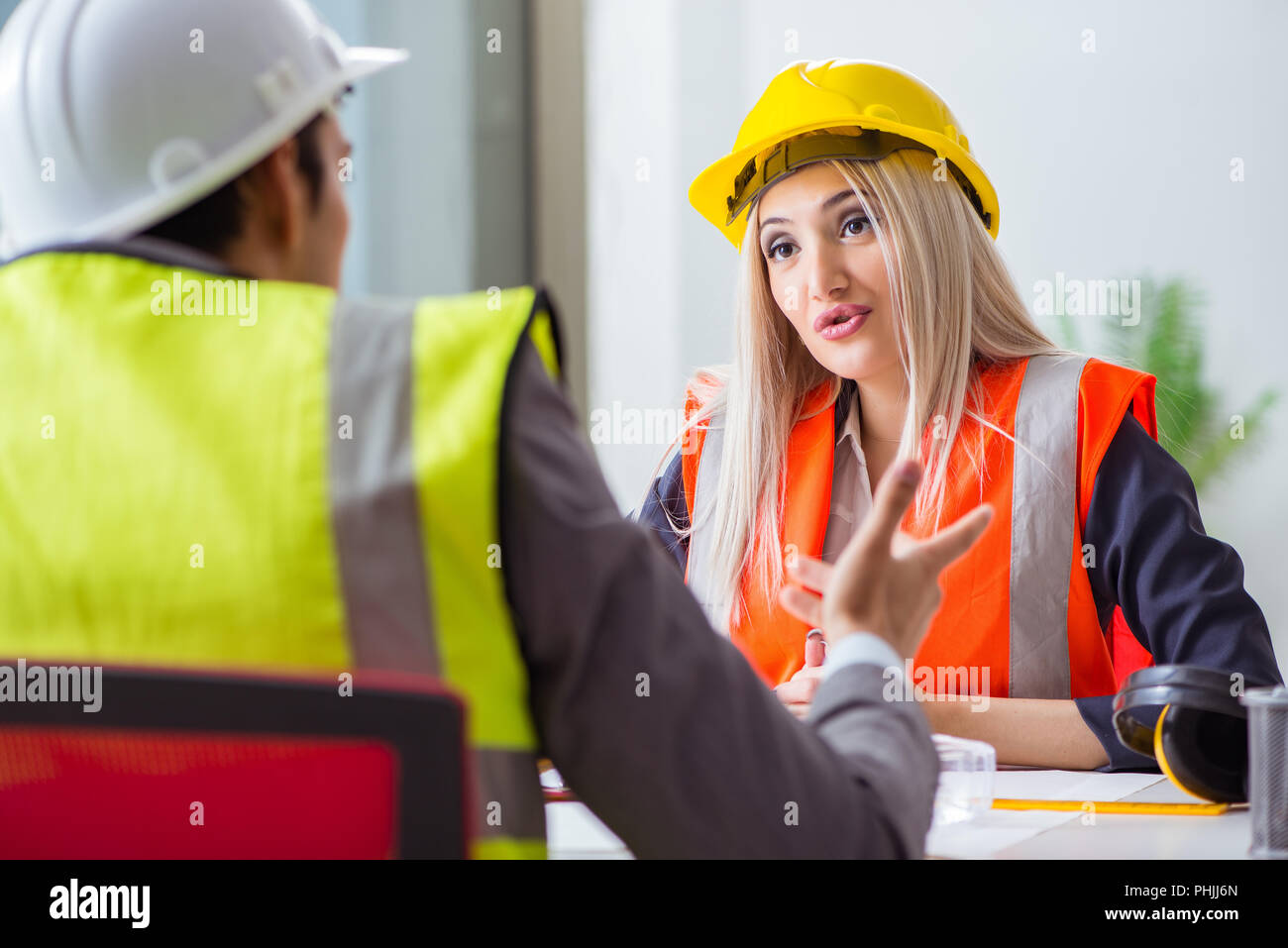 Construction workers having discussion in office before starting Stock ...
