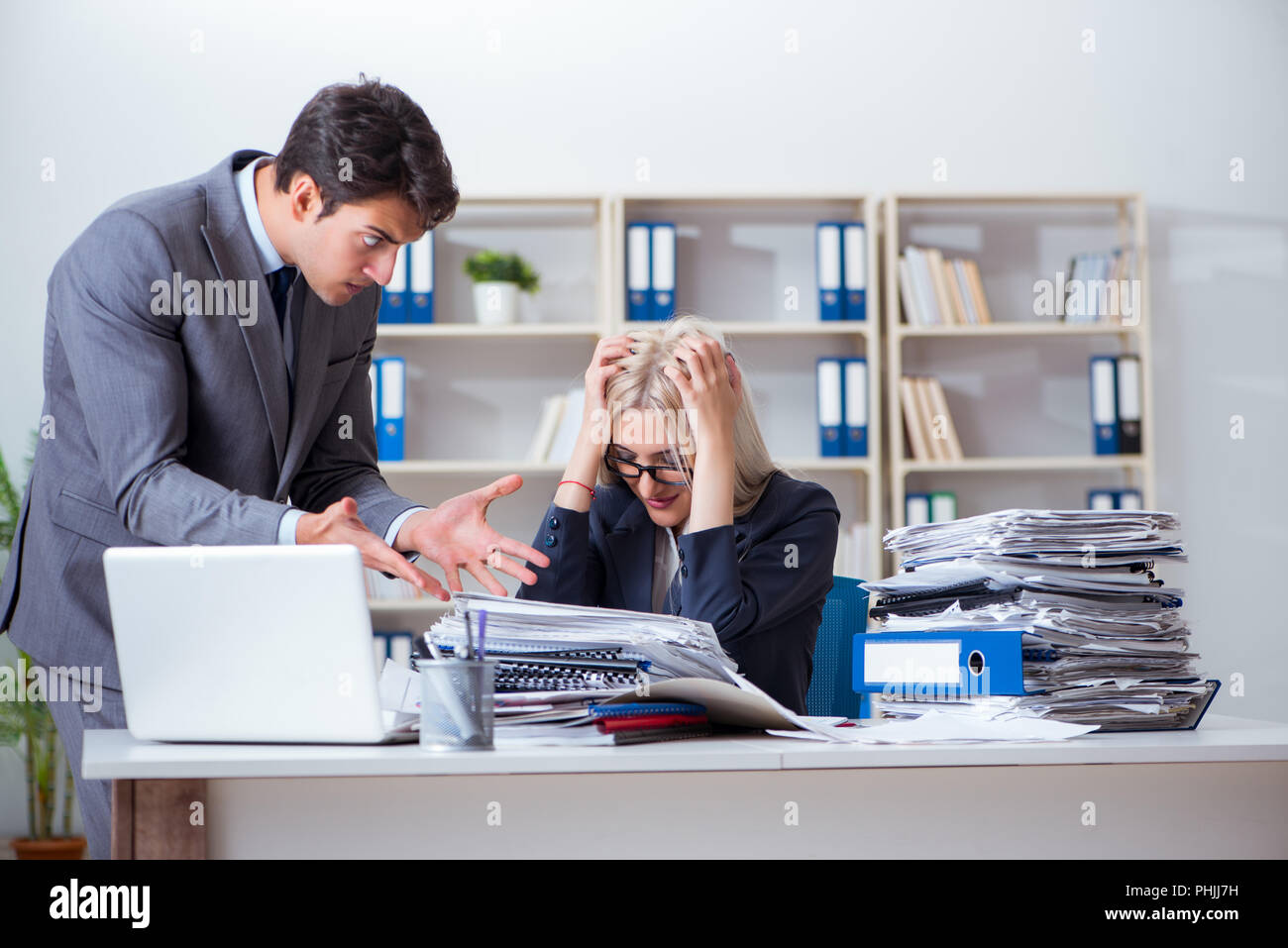 Angry irate boss yelling and shouting at his secretary employee Stock ...
