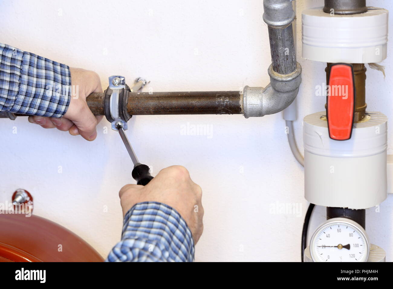 worker is fixing a pipe Stock Photo - Alamy