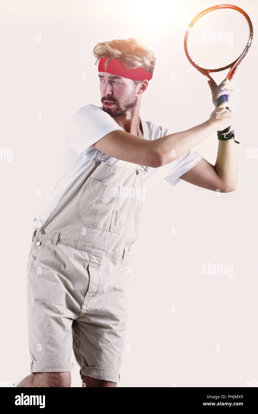 Male tennis player with racket in action Stock Photo - Alamy