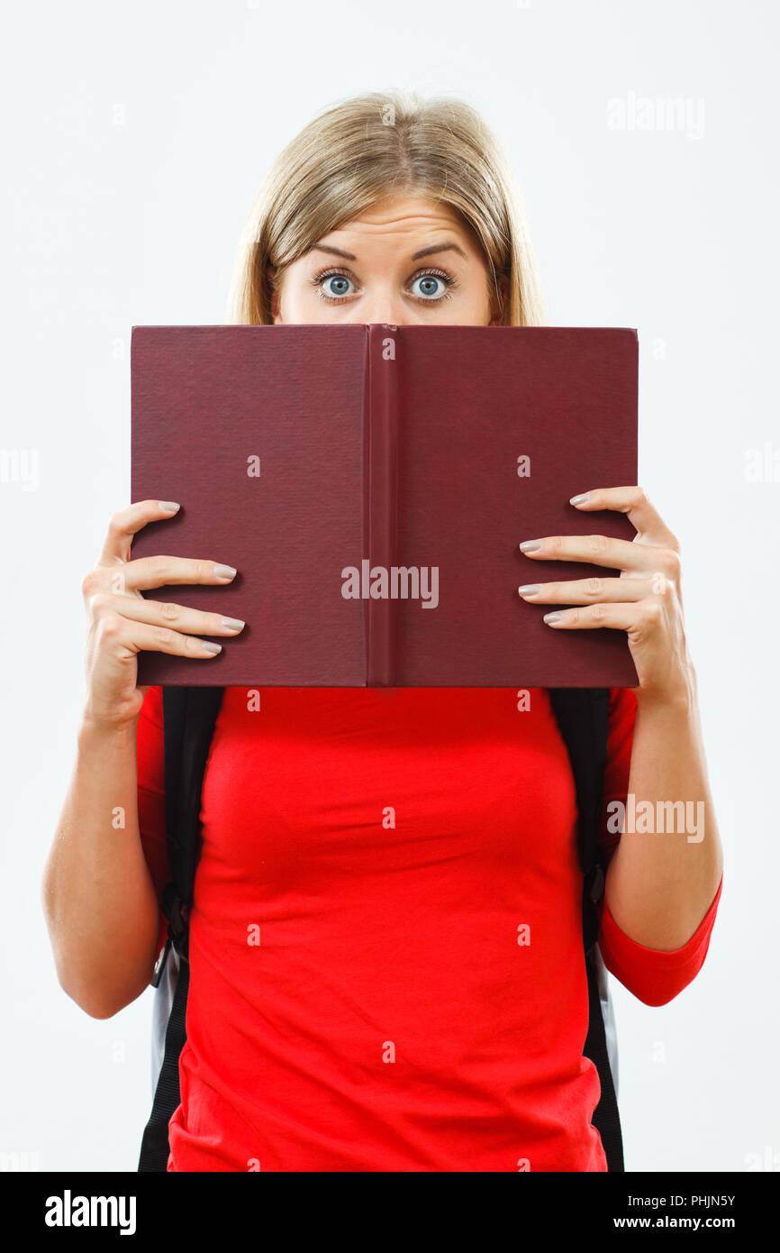 Student hiding behind book Stock Photo - Alamy