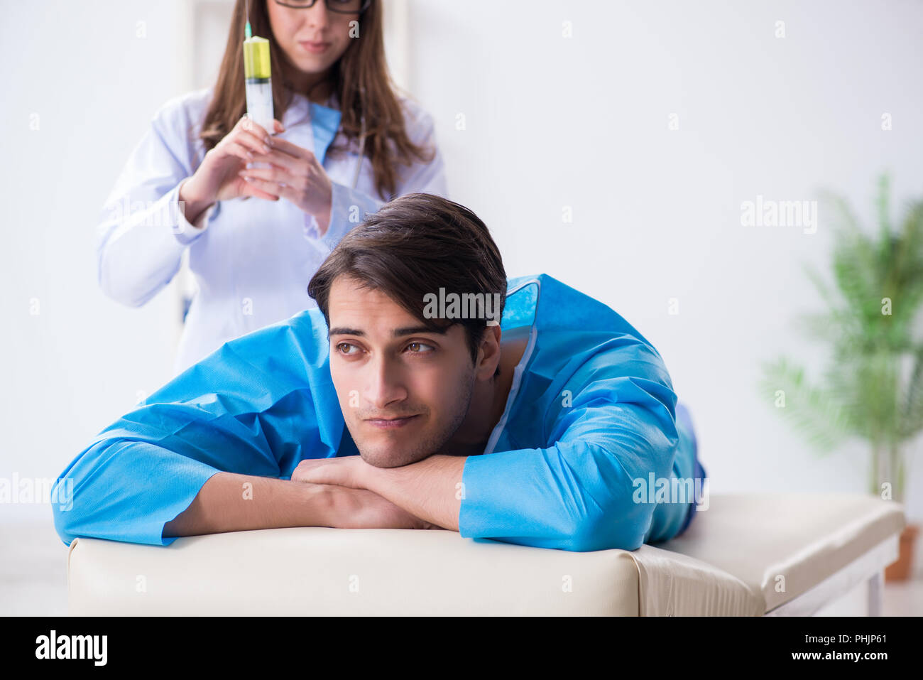 Funny man getting ready for buttocks syringe shot Stock Photo - Alamy