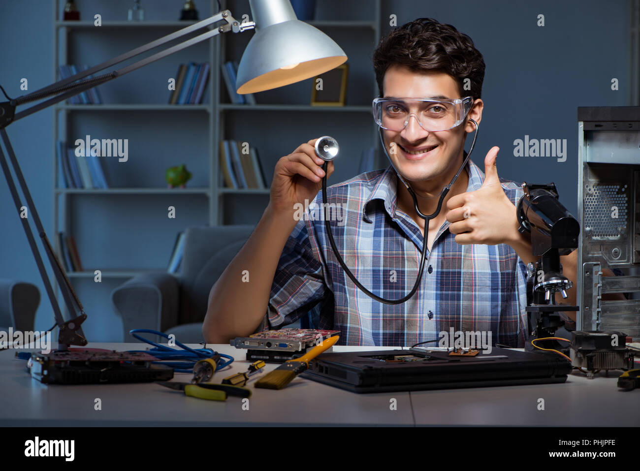 Computer repair concept with man inspecting with stethoscope Stock ...