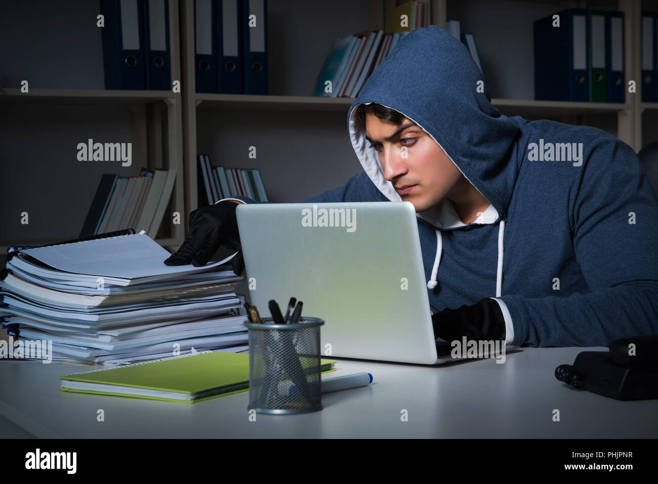 Young hacker hacking into computer at night Stock Photo - Alamy