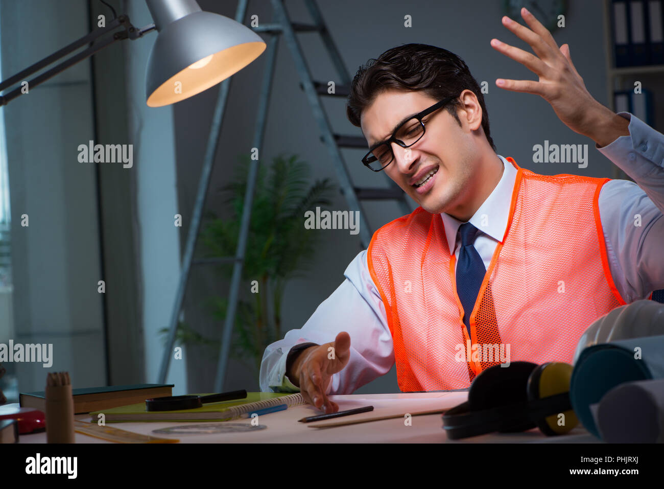 Construction architect working on drawings late at night Stock Photo ...