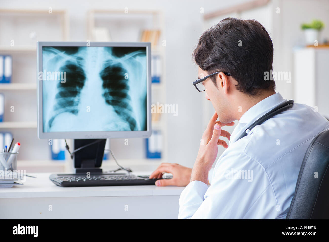 Doctor radiologist looking at x-ray images Stock Photo - Alamy