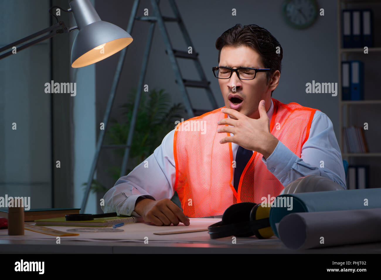 Construction architect working on drawings late at night Stock Photo ...