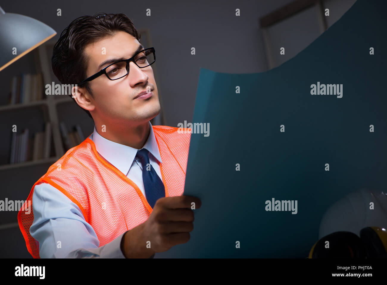 Construction architect working on drawings late at night Stock Photo ...
