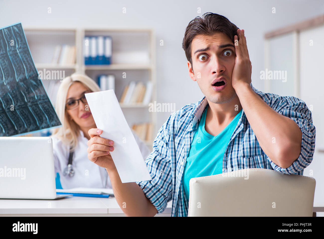 Male patient angry at expensive healthcare bill Stock Photo - Alamy