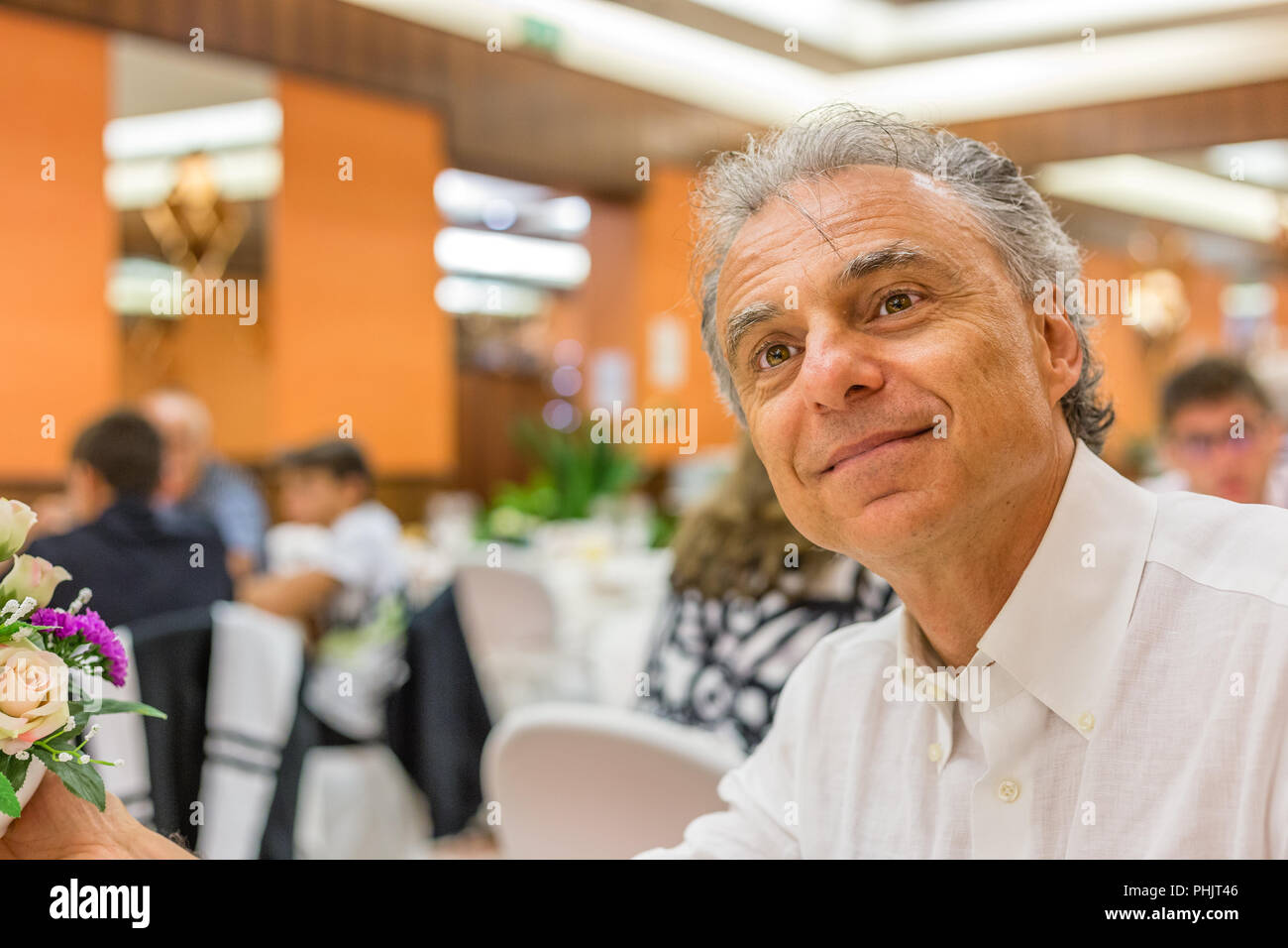 Old man is smiling while having dinner at Italian restaurant Stock ...