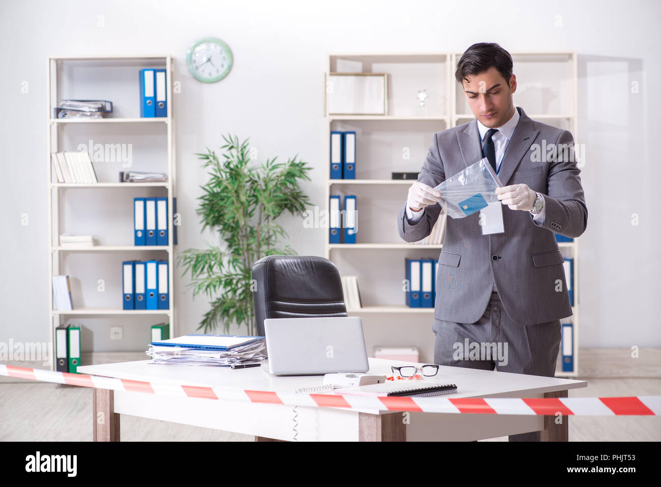 Forensics investigator at the scene of office crime Stock Photo - Alamy
