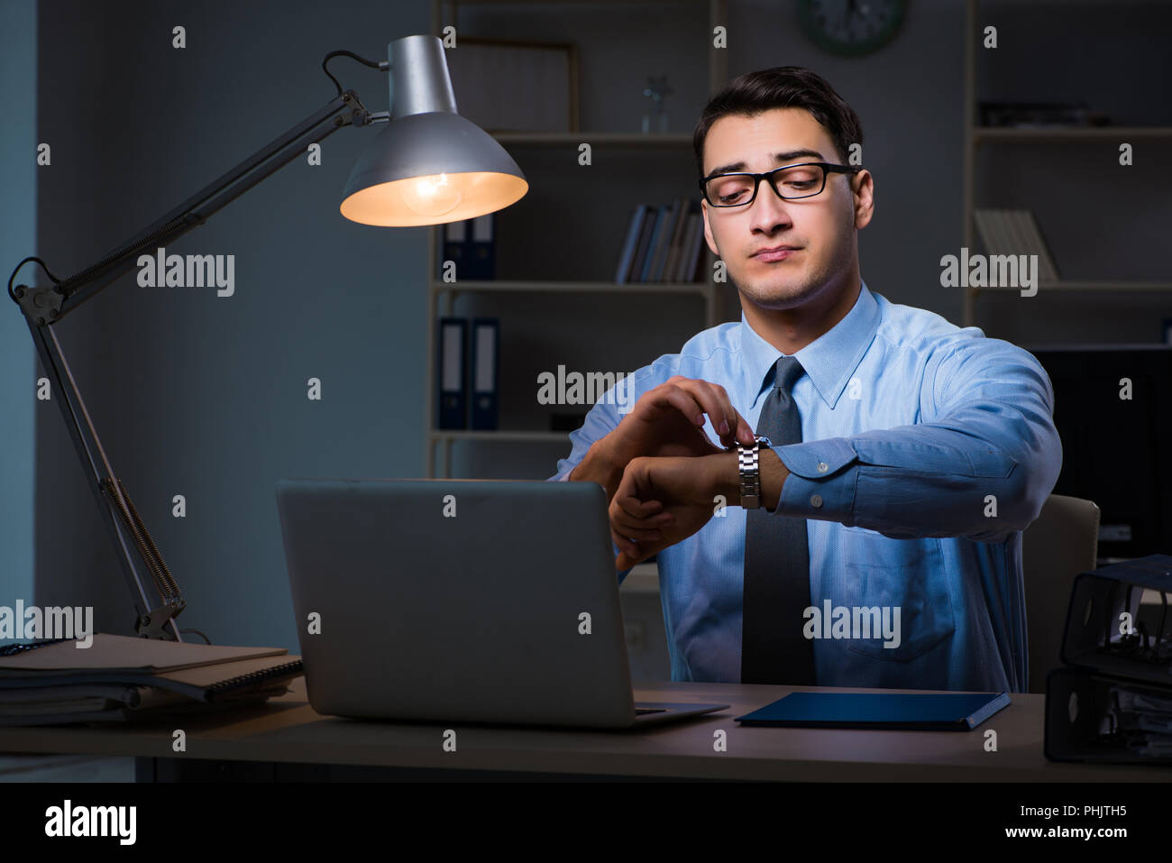Employee working late at night at important report Stock Photo - Alamy