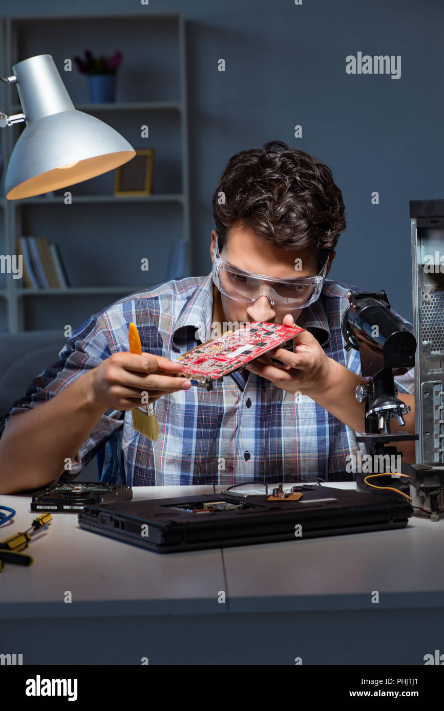 Computer repair man cleaning dust with brush Stock Photo - Alamy