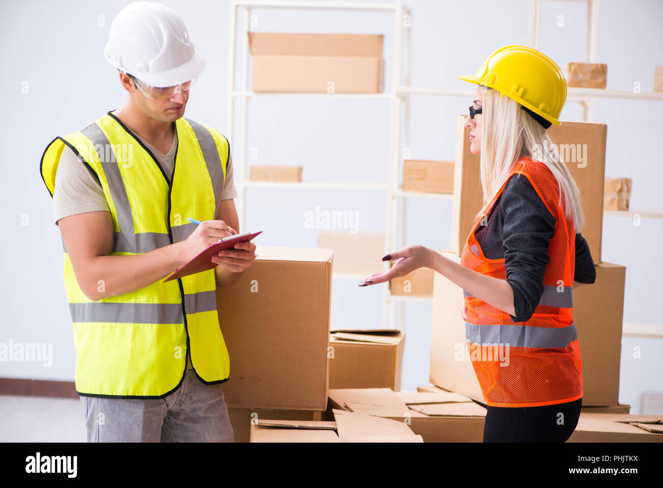 Delivery contractor delivering boxes to office Stock Photo - Alamy