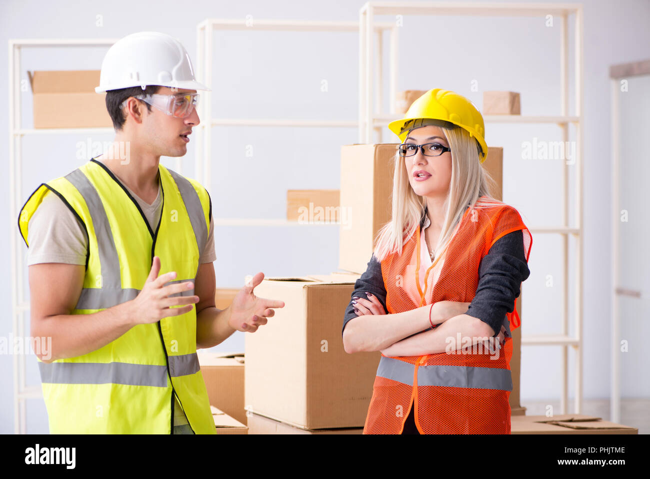 Delivery contractor delivering boxes to office Stock Photo - Alamy