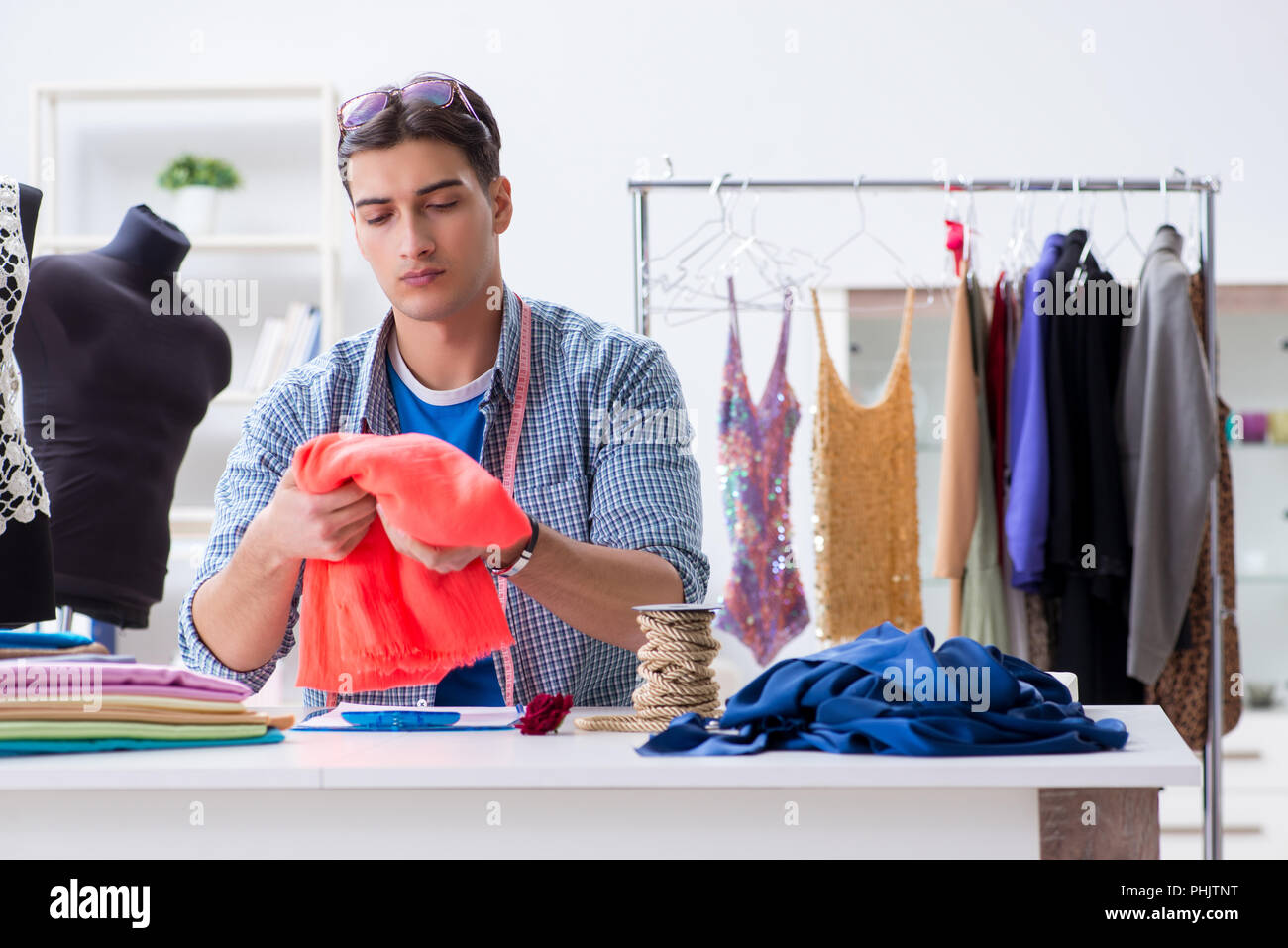 Male tailor with female student in workshop Stock Photo - Alamy