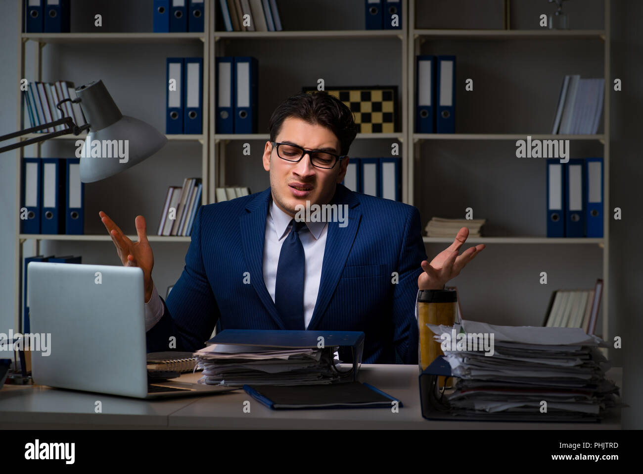 Employee working late to finish important deliverable task Stock Photo ...