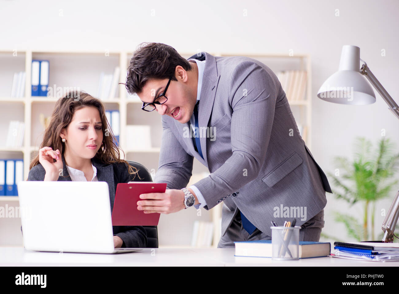 Angry boss unhappy with female employee performance Stock Photo - Alamy