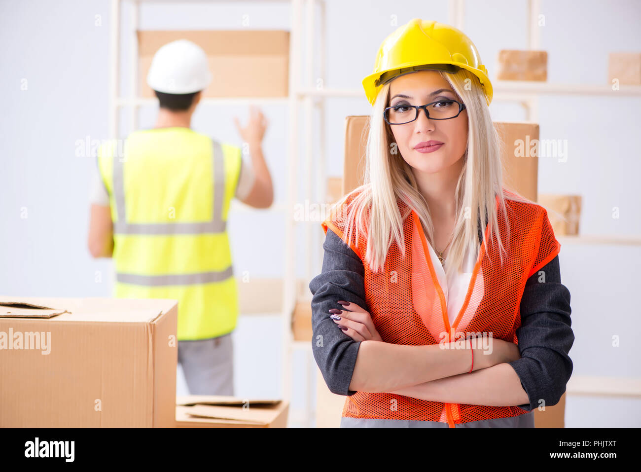 Delivery contractor delivering boxes to office Stock Photo - Alamy