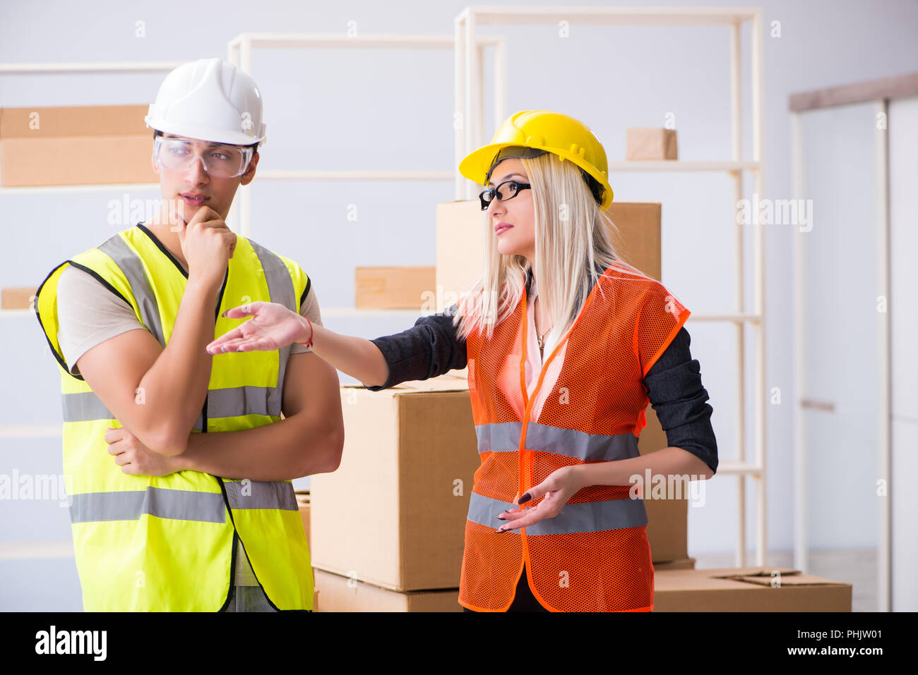 Delivery contractor delivering boxes to office Stock Photo - Alamy