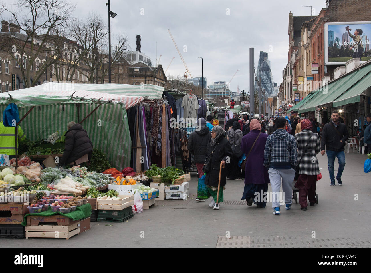 View of shoppers and market stalls on Whitechapel Road, Tower Hamlets ...