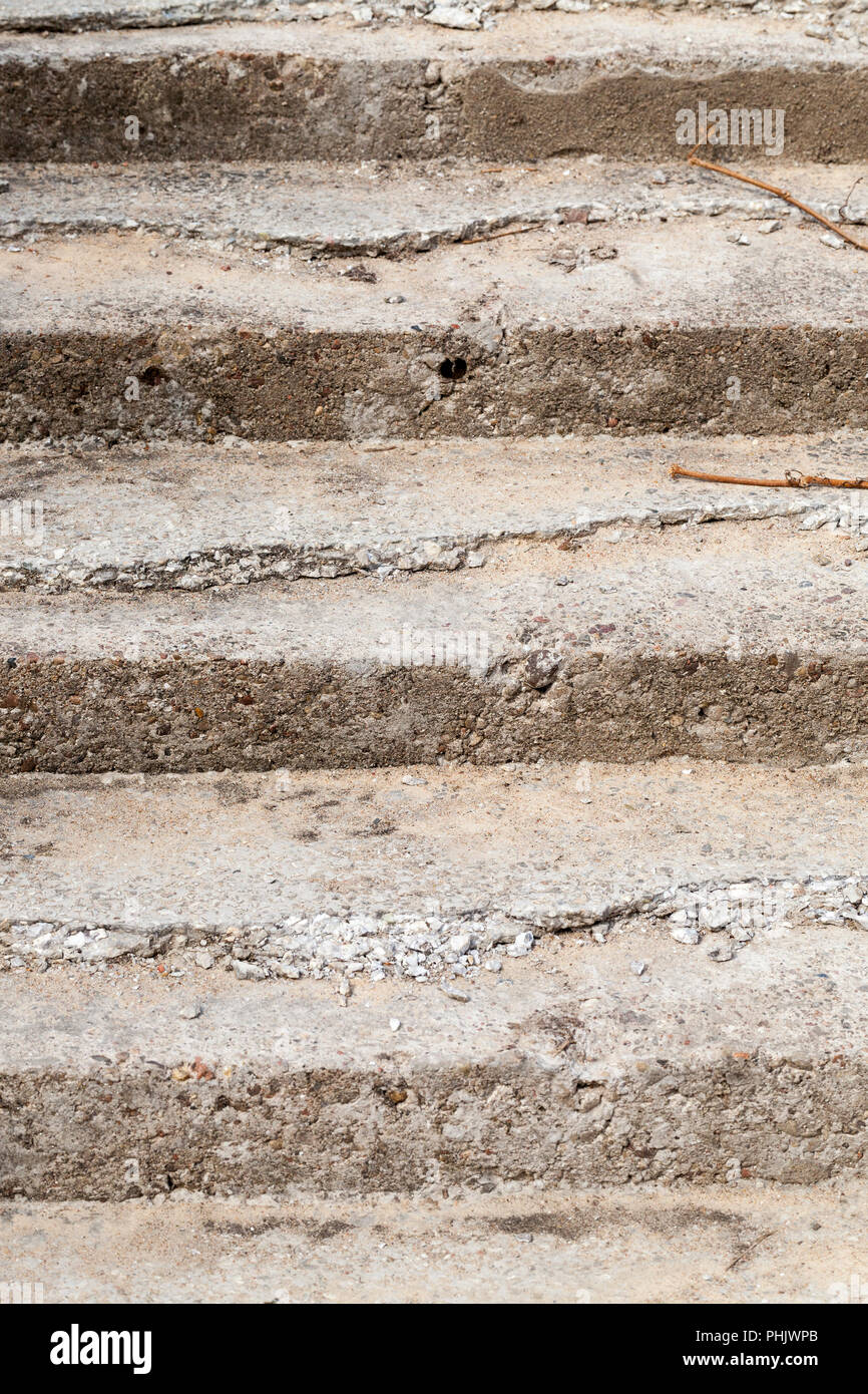 crumbling old concrete staircase made of cement, closeup in an old park ...