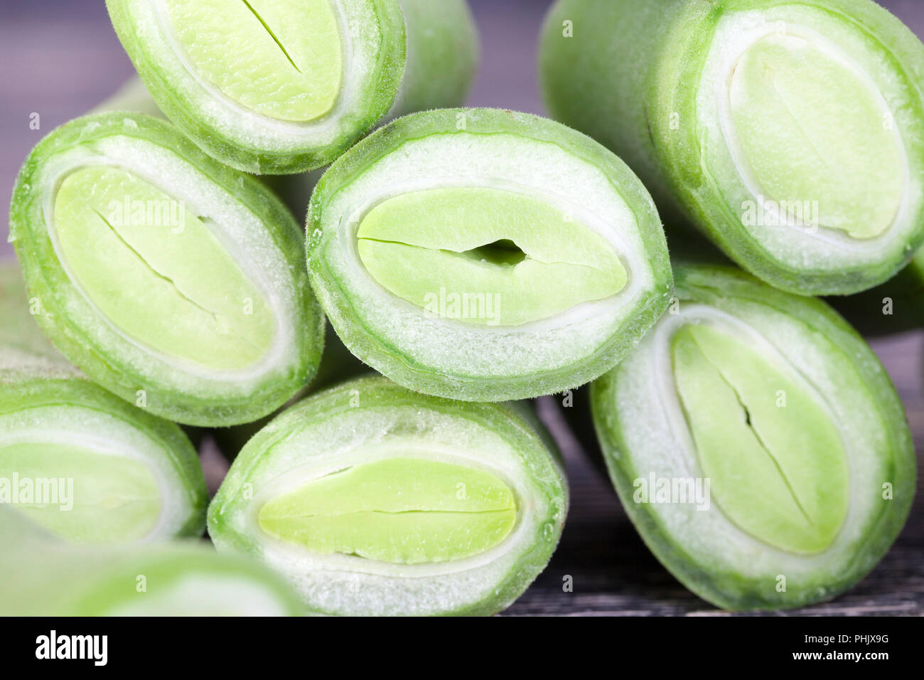 green unripe and soft seeds of beans and pods, cut into half and seen ...