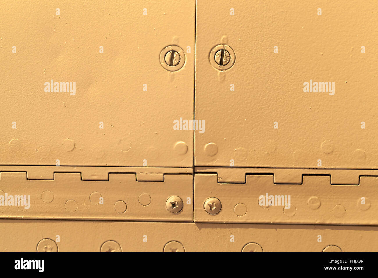 orange metal sheet connected by rivets, close-up of a part of the ...