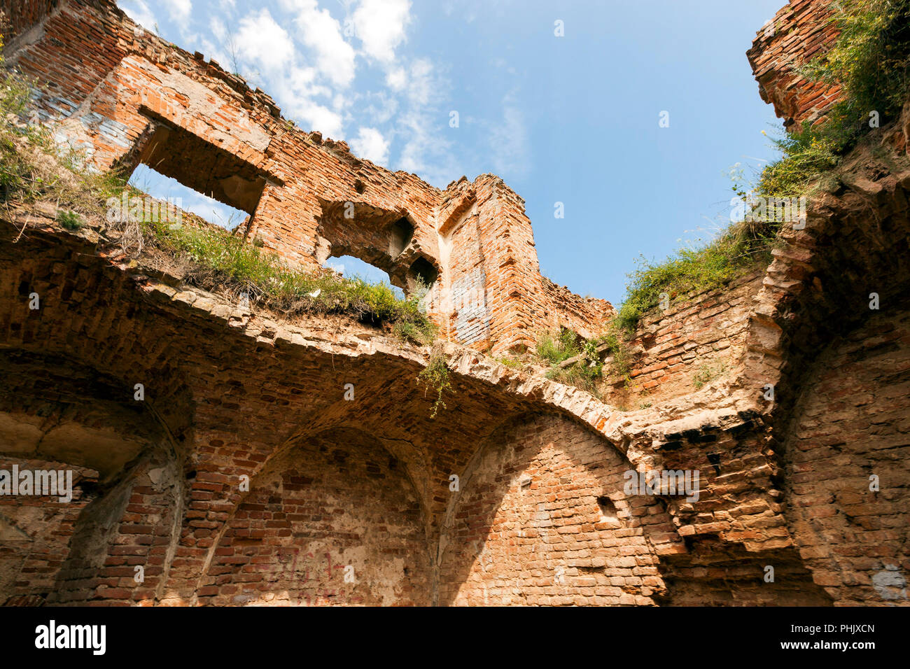 ruins of walls and towers of an ancient fortification of red brick ...