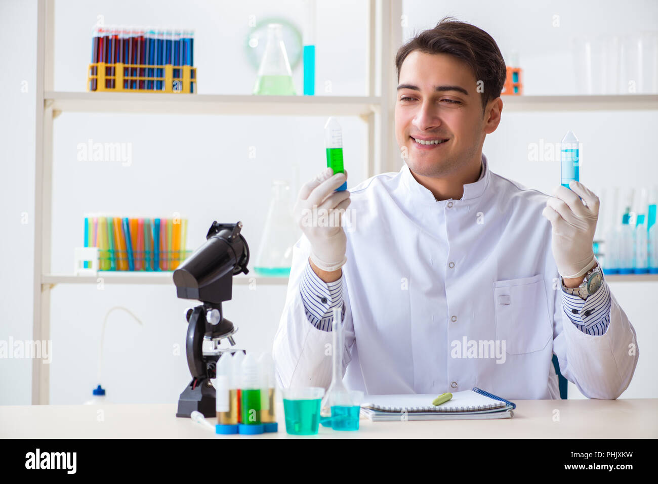 Young chemist student working in lab on chemicals Stock Photo - Alamy