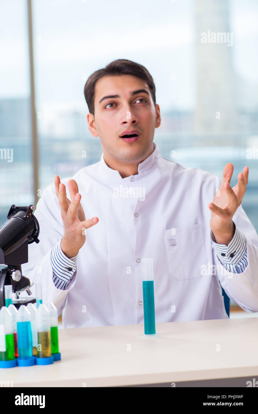 Young chemist student working in lab on chemicals Stock Photo - Alamy