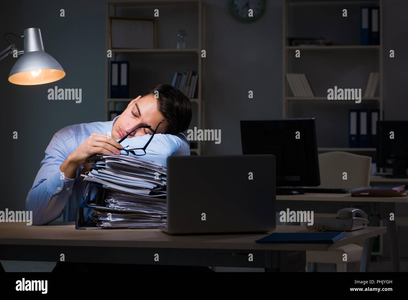 Employee working late at night at important report Stock Photo - Alamy