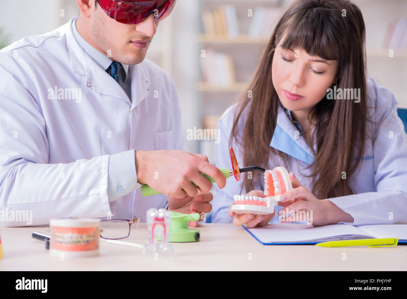 Doctor explaining to assistant how to use ultraviolet gun Stock Photo ...