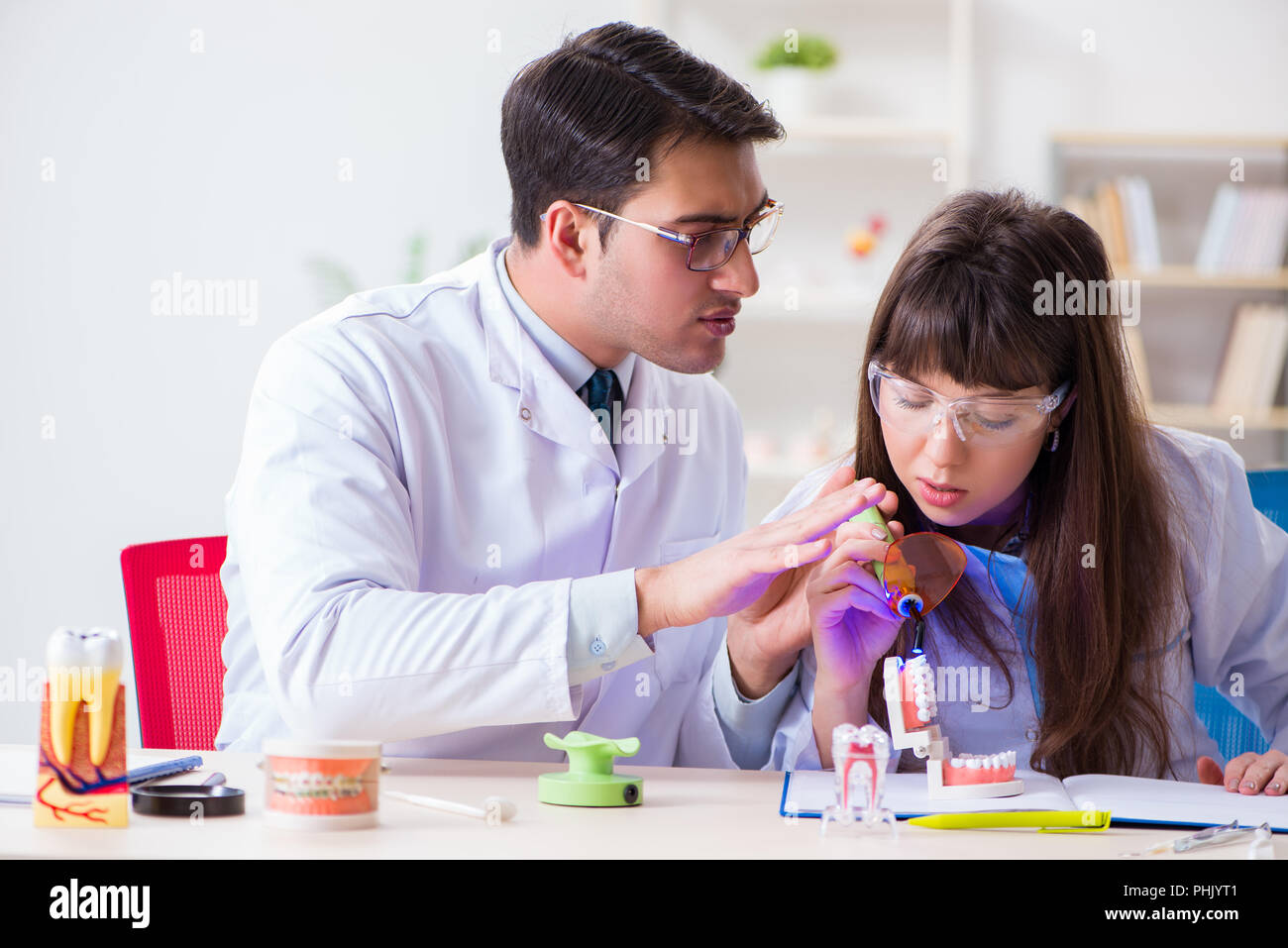 Doctor explaining to assistant how to use ultraviolet gun Stock Photo ...