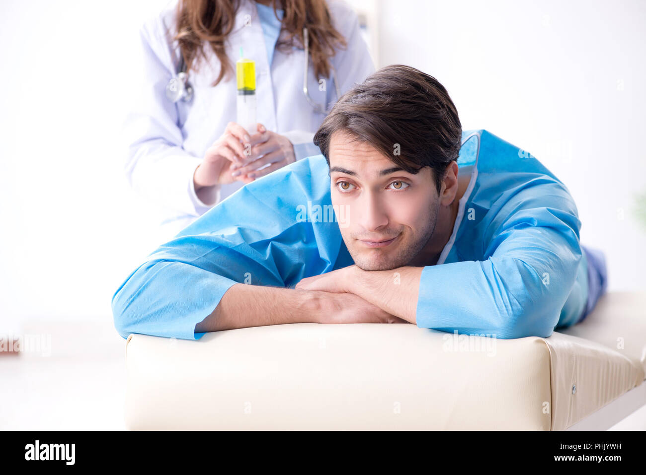 Funny man getting ready for buttocks syringe shot Stock Photo - Alamy