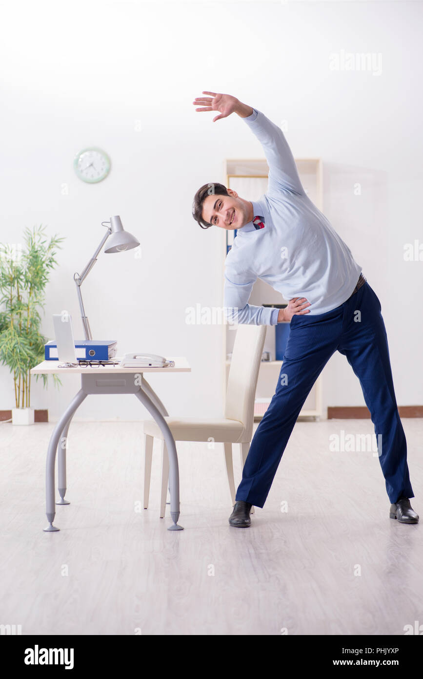 Employee doing stretching exercises in the office Stock Photo - Alamy