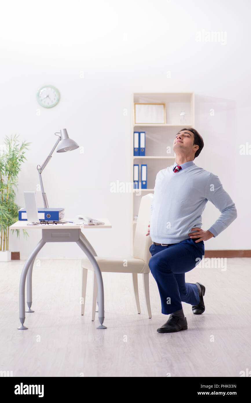Employee doing stretching exercises in the office Stock Photo - Alamy