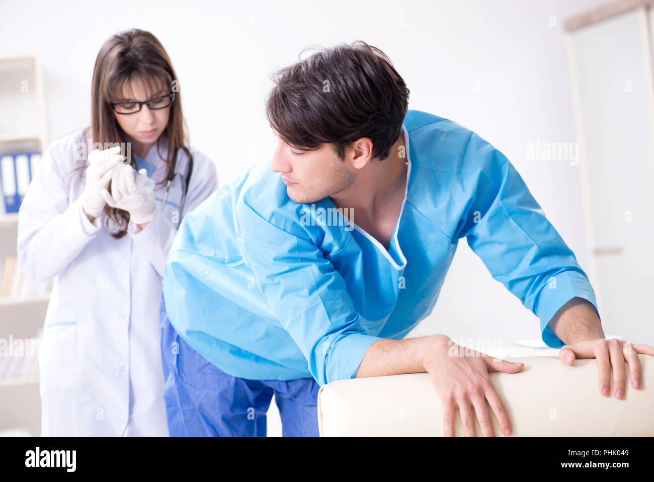 Funny man getting ready for buttocks syringe shot Stock Photo - Alamy