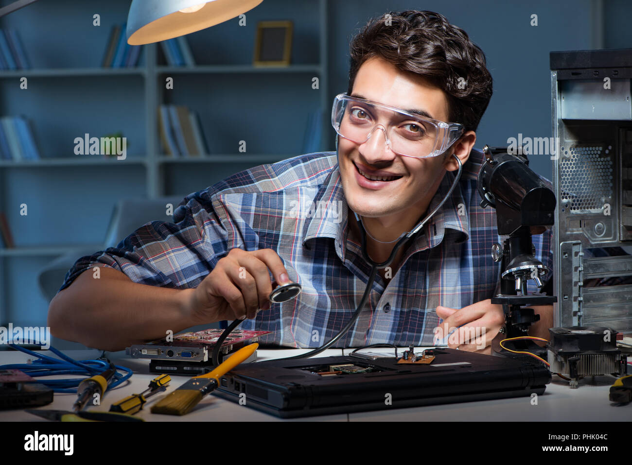 Computer repair concept with man inspecting with stethoscope Stock ...