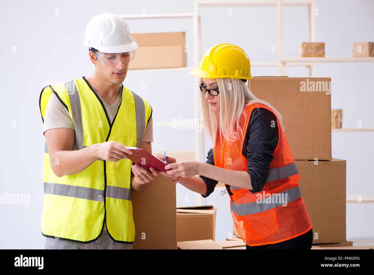 Delivery contractor delivering boxes to office Stock Photo - Alamy